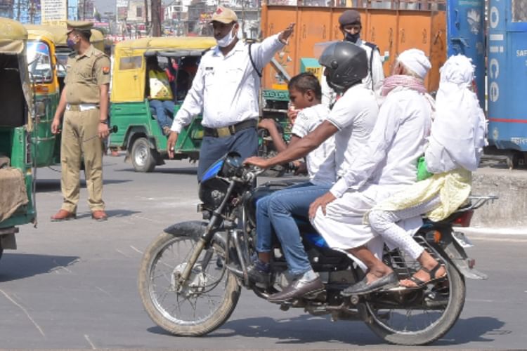Two-wheelers Running Without Helmets Four Riders On A Bike, Triple ...