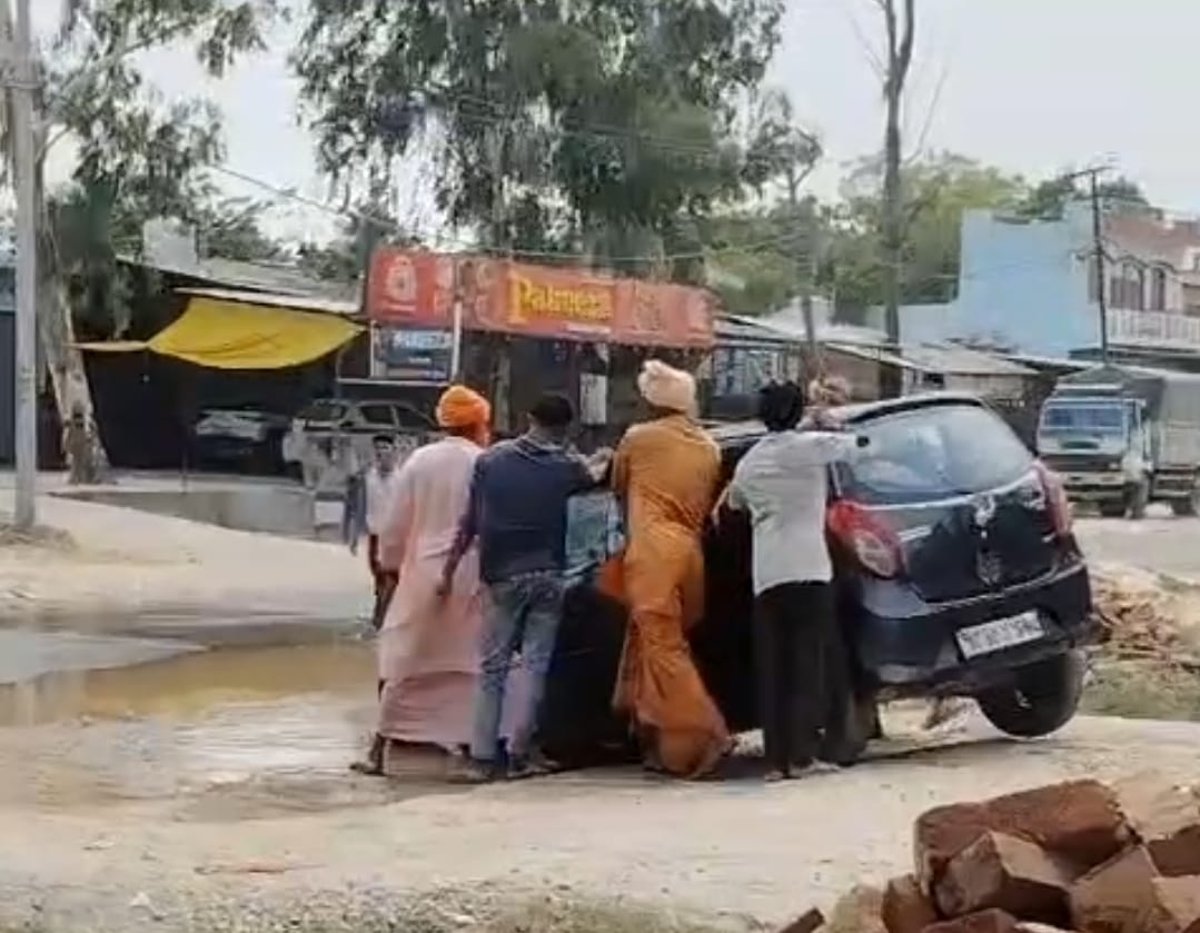 A Broken Pipeline Caused Waterlogging On The Road, Leaving A Car Stuck ...